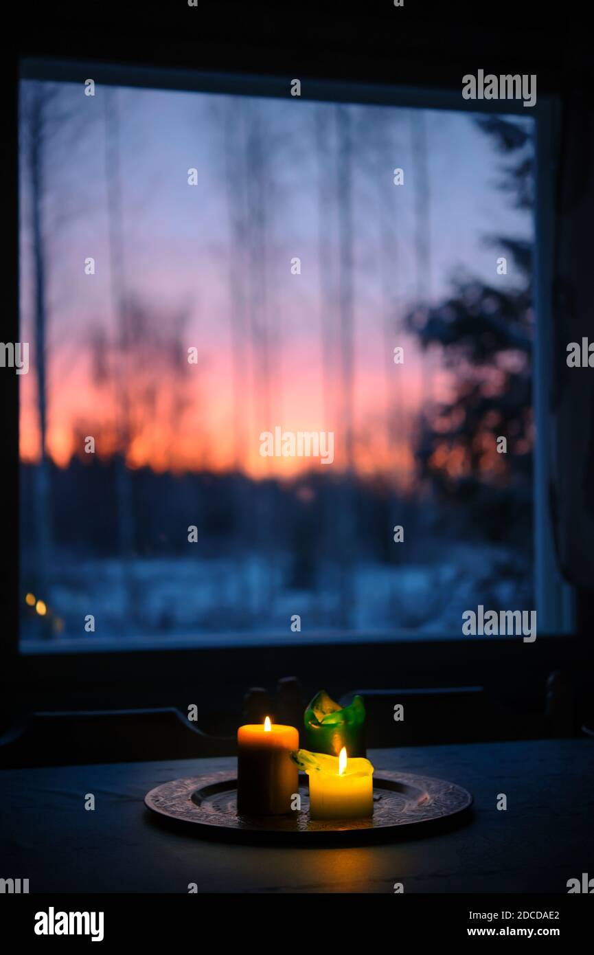 Candles on the table, sunset sky in the background Stock Photo - Alamy