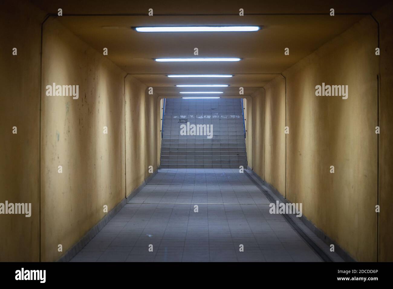 Underground railway station passage with lights and yellow walls Stock ...