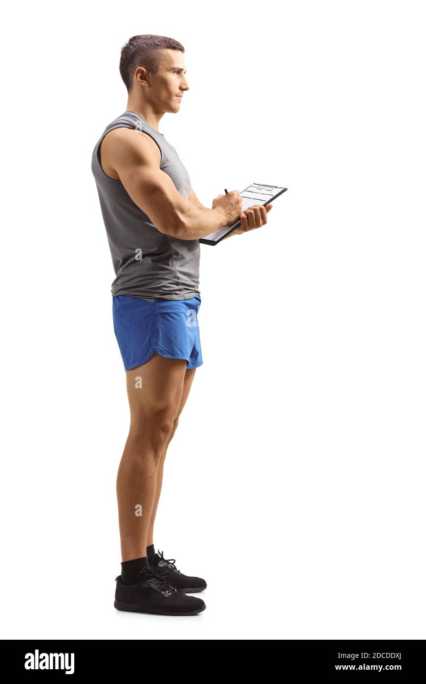 Full length profile shot of a male fitness trainer writing a document ...