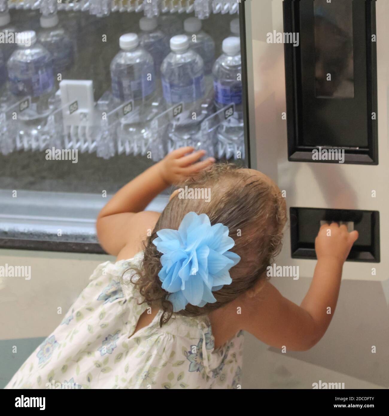 little girl playing in a water vending machine Stock Photo - Alamy
