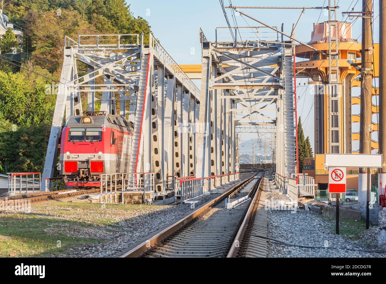 Passenger train moves through the bridge. Sochi.. Russia Stock Photo ...