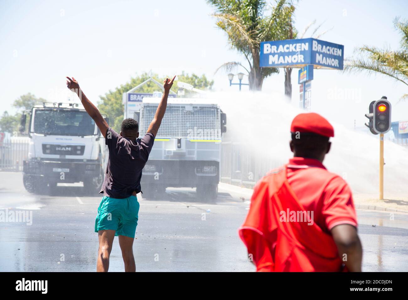 Police vehicles firing water cannons at protesters during the ...