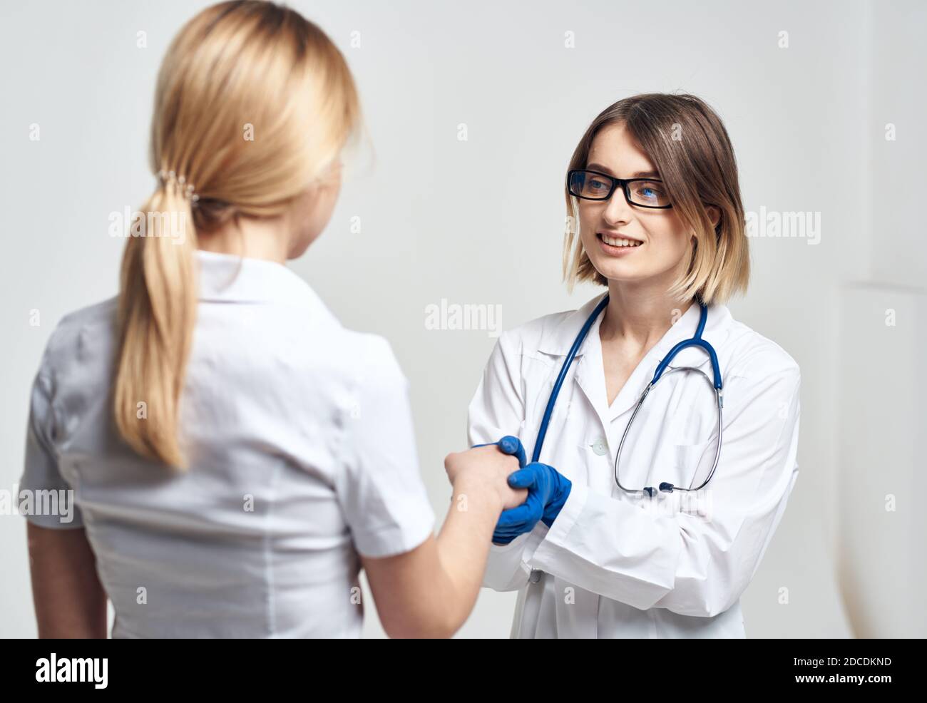 Doctor and patient near window in hospital interior Stock Photo - Alamy
