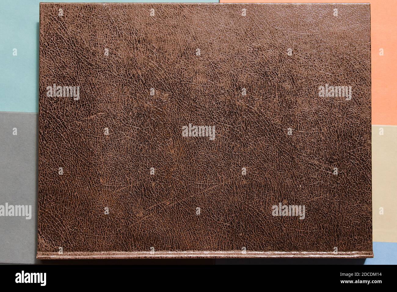 Black liquid stained leather book cover creates an abstract aerial ...