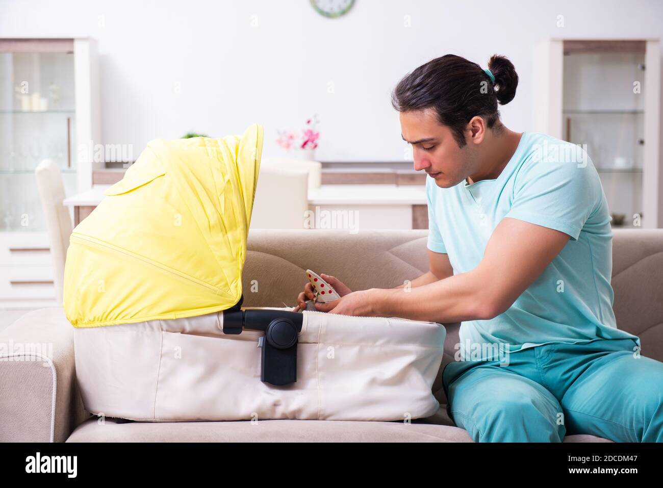 Young man parent looking after newborn at home Stock Photo - Alamy
