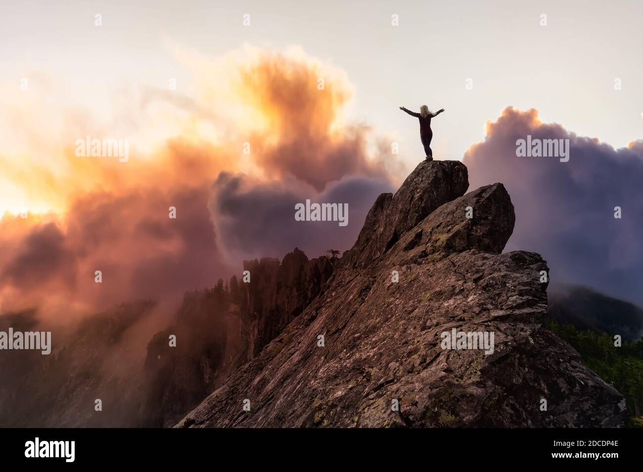 Adventurous Girl on top of a Mountain Peak Stock Photo - Alamy