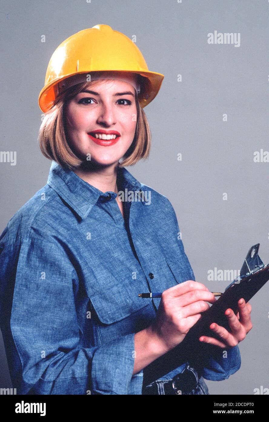 Female construction supervisor checks her clipboard, USA, 1991 Stock ...