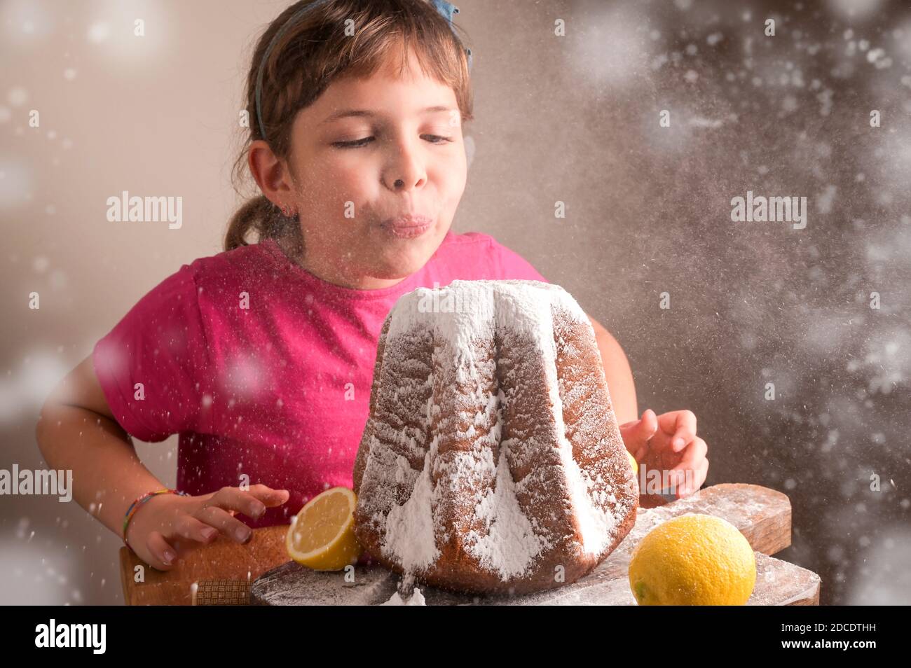 Little girl blowing icing sugar off the Soft star-shaped pasta ...