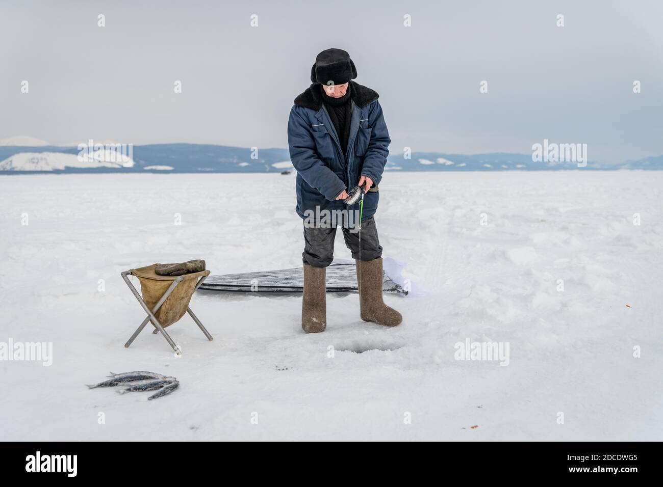 Baikal lake, Siberia, Russia - March 05, 2020 : Winter ice fishing. A ...