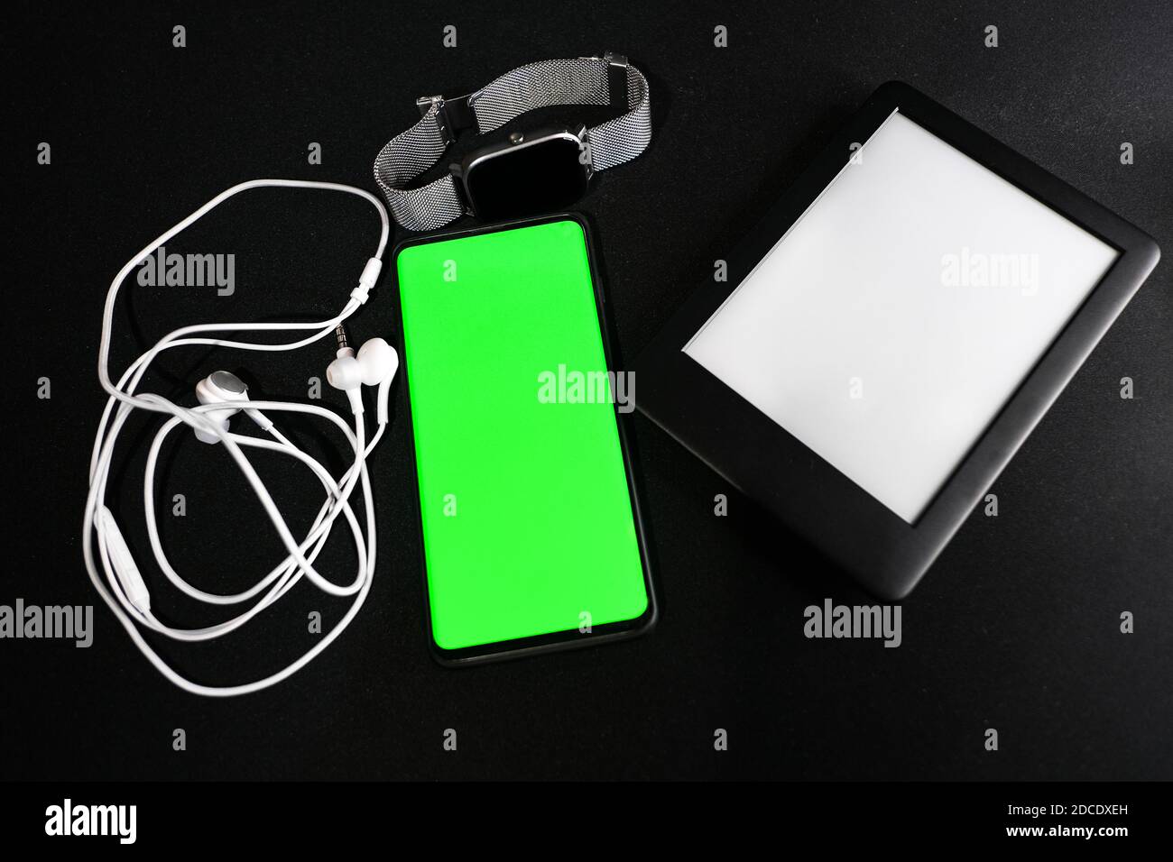 Bunch of hi tech devices,earphones,smartphone,ebook reader and ...