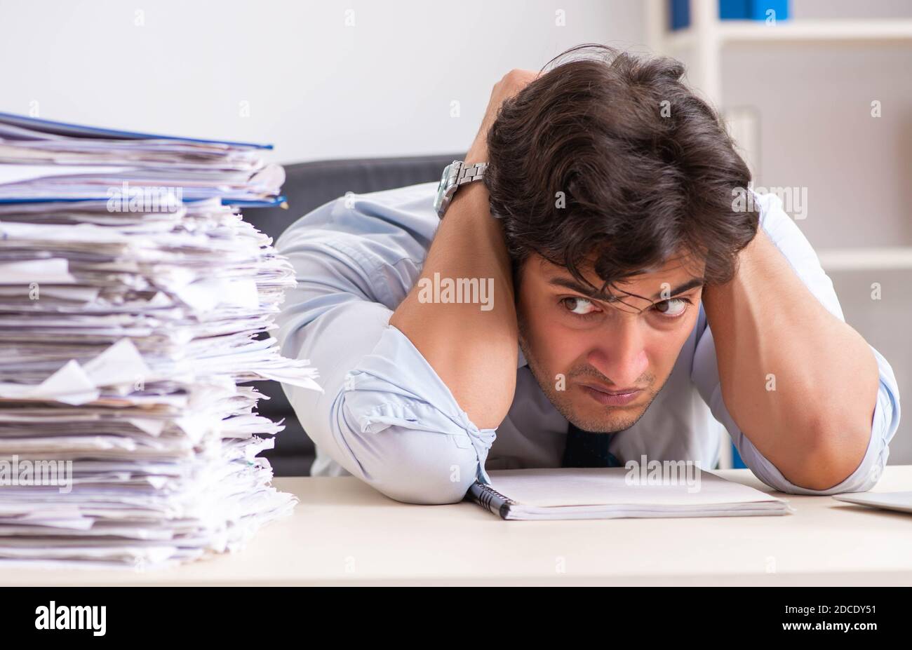 The overloaded busy employee with too much work and paperwork Stock ...