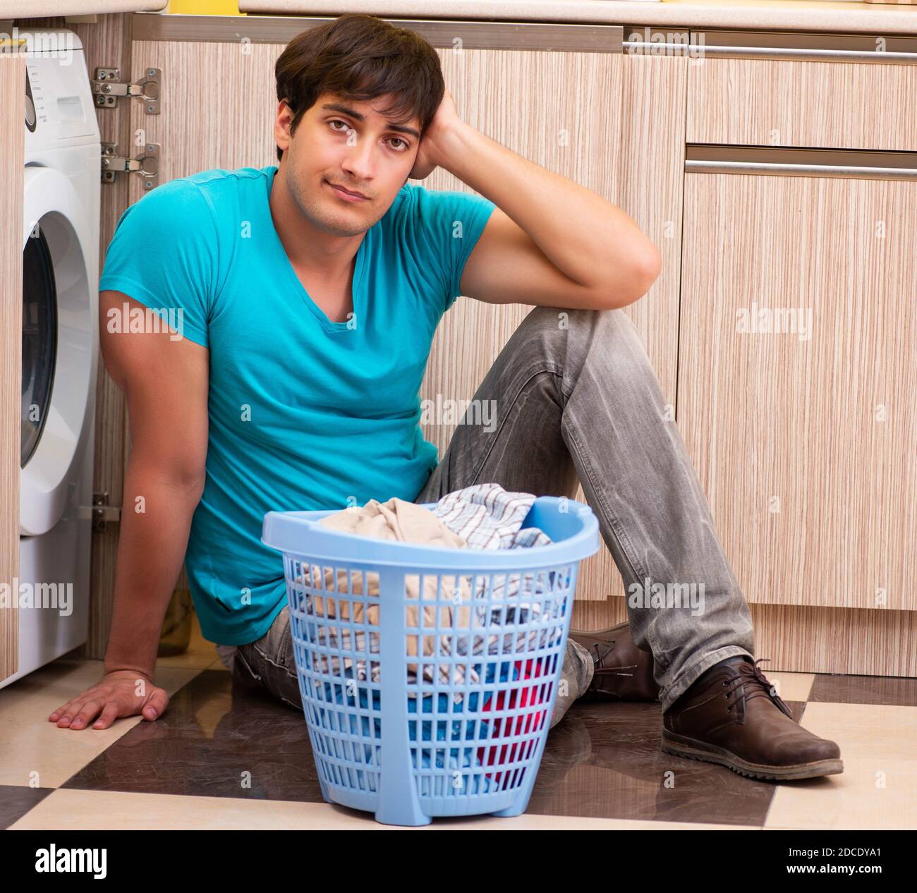 The young husband man doing laundry at home Stock Photo - Alamy