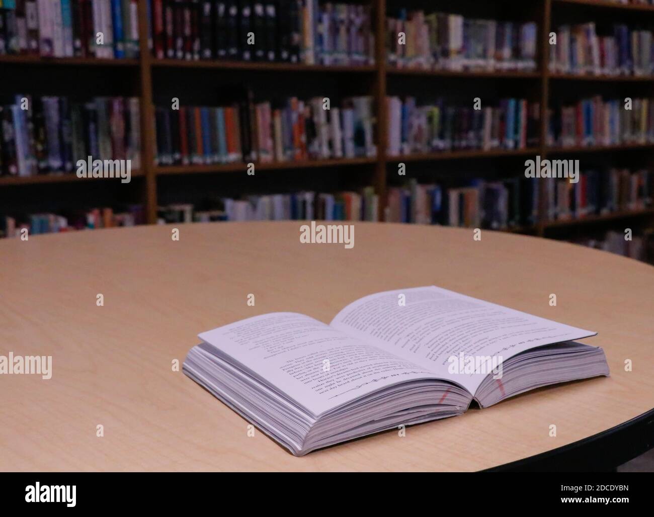 Angled photo of an open book in a library Stock Photo - Alamy
