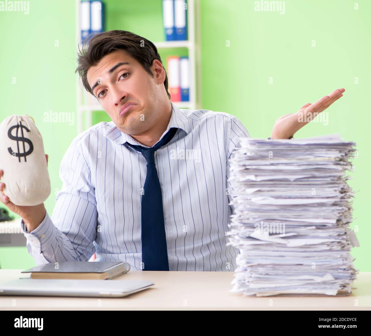 The businessman having problems with paperwork and workload Stock Photo ...