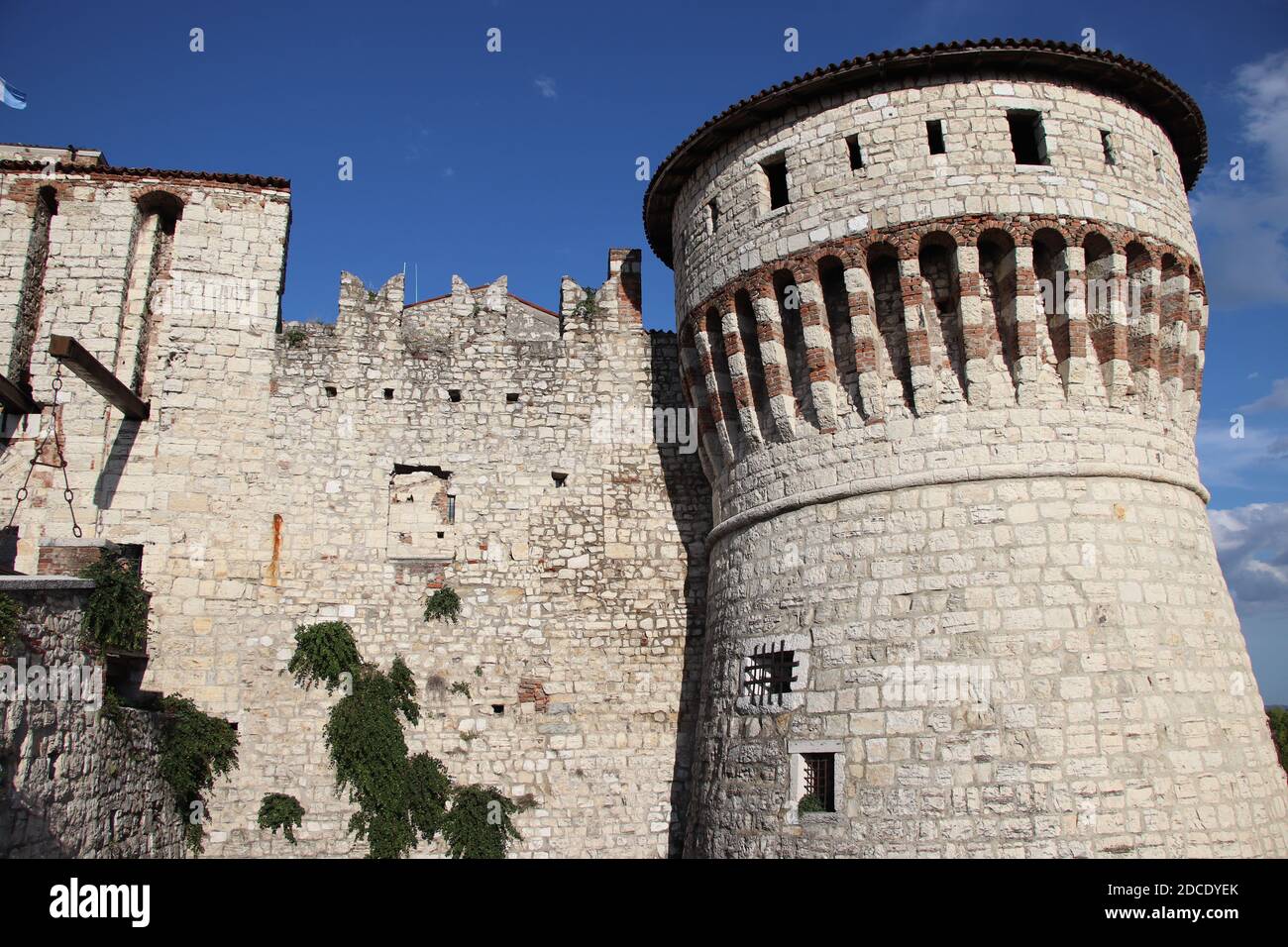 Stone wall with merlons and drawbridge gate of medieval castle of ...