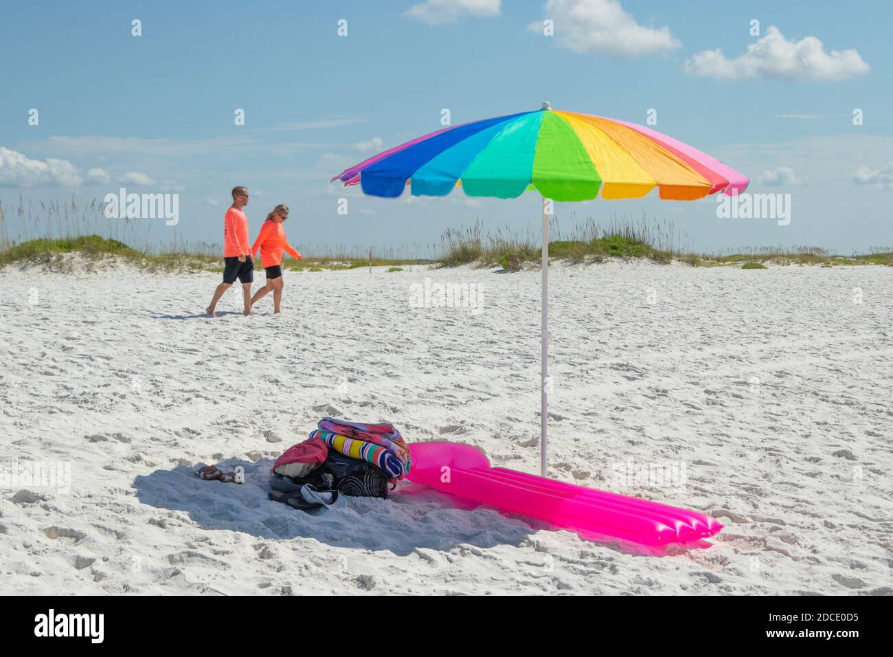 isolated colourful rainbow sun parasol shade with man and woman couple ...