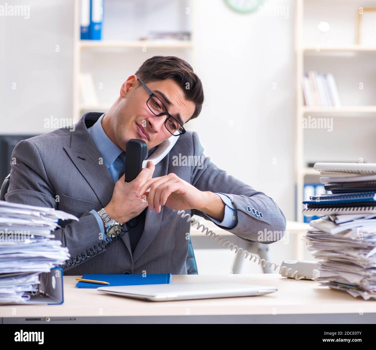 The desperate sad employee tired at his desk in call center Stock Photo ...