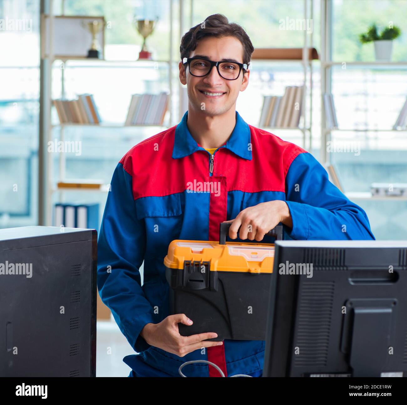 The computer repairman working on repairing computer in it workshop ...