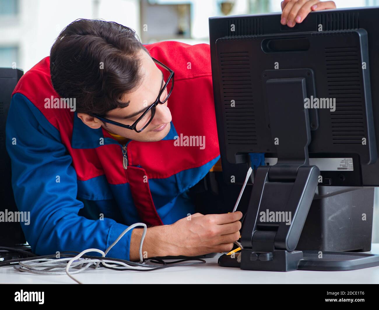 The computer repairman working on repairing computer in it workshop ...