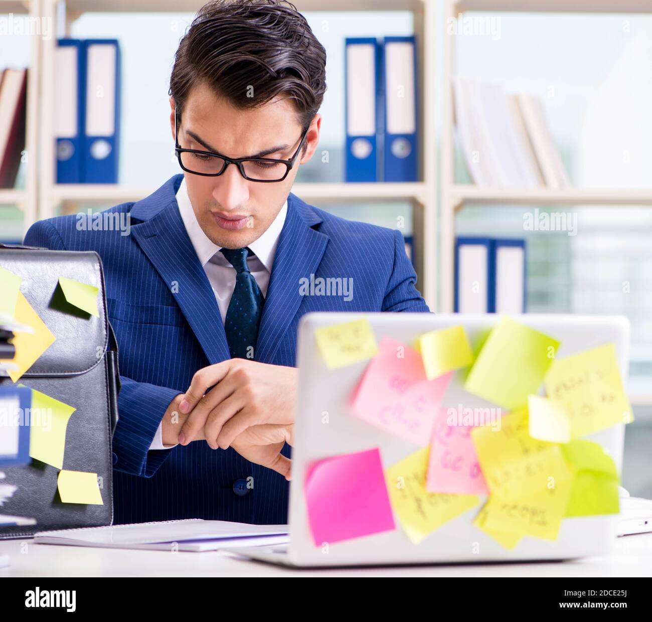 The businessman with reminder notes in multitasking concept Stock Photo ...