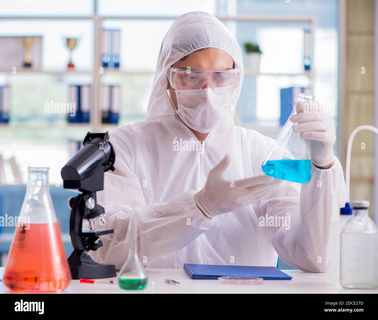The chemist working in the laboratory with hazardous chemicals Stock ...