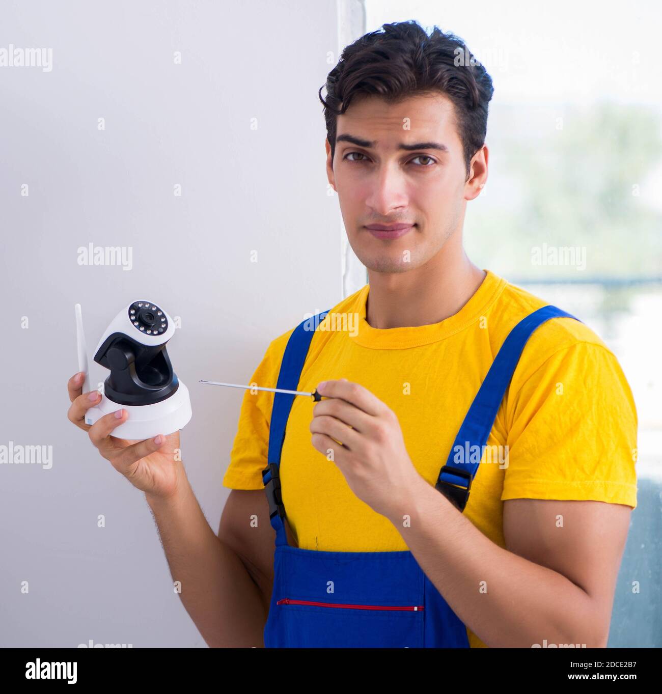 The contractor installing surveillance cctv cameras in office Stock ...