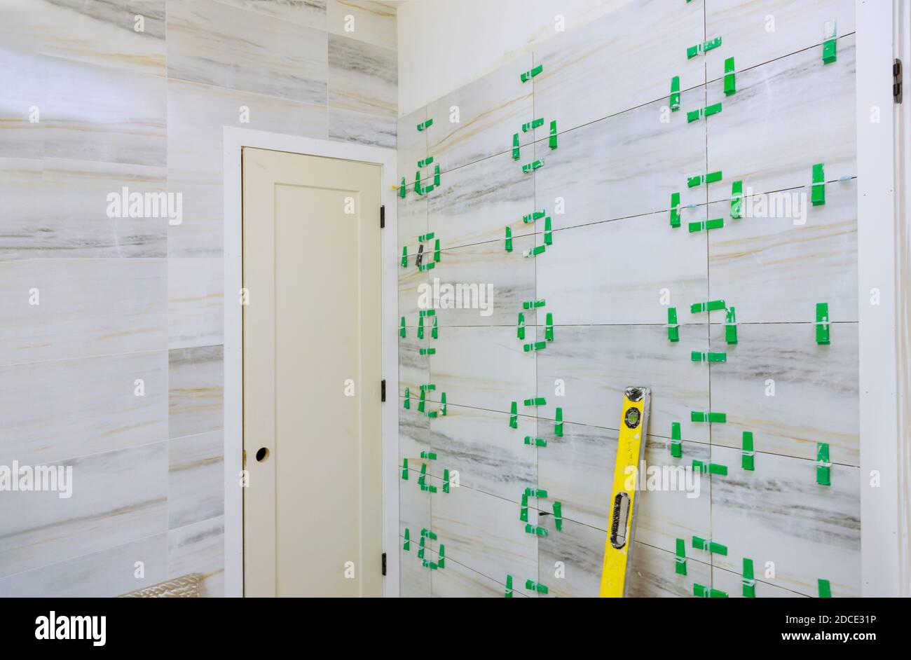 Construction installing ceramic tile on reconstruction of bathroom ...