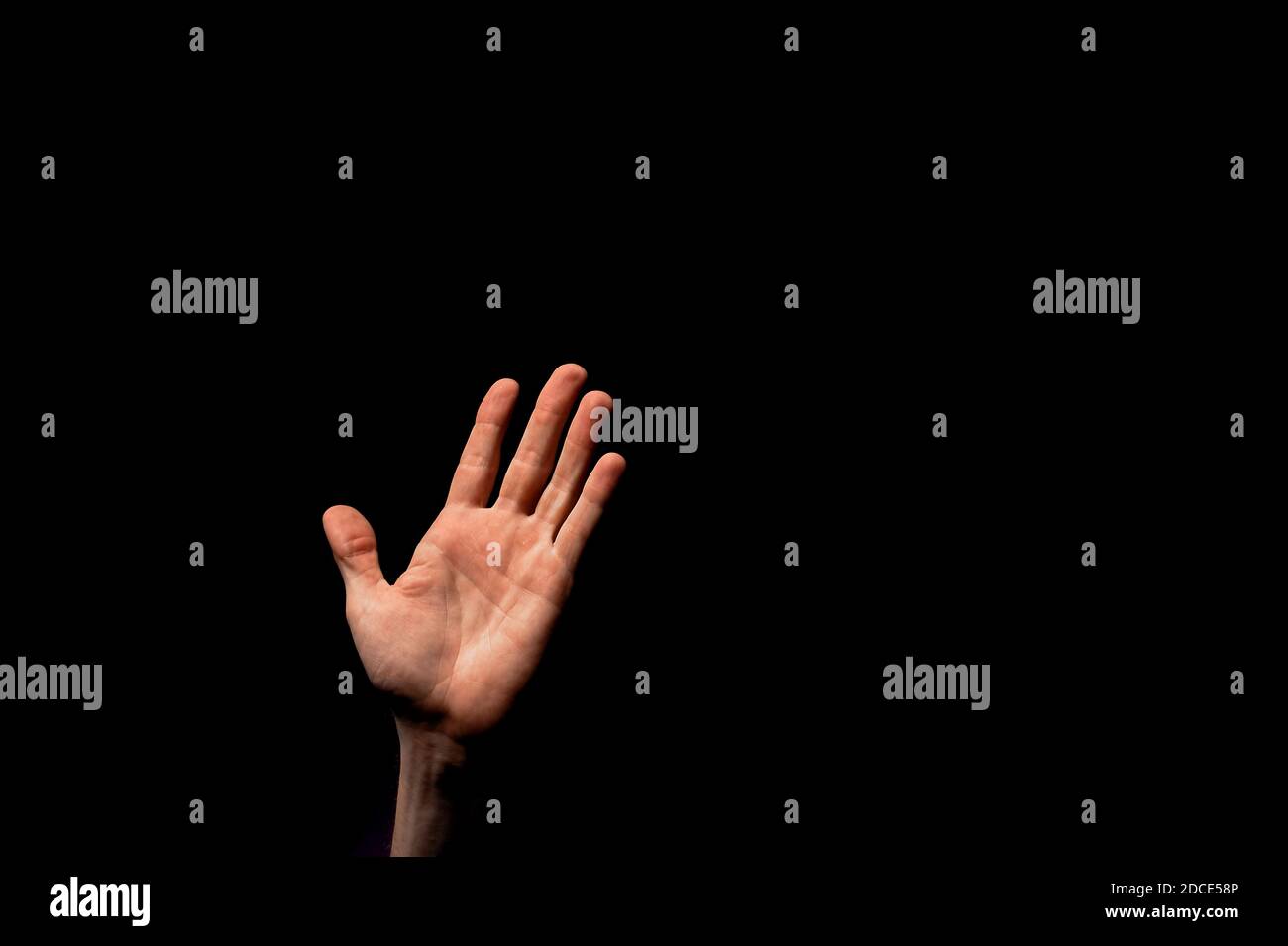 An outstretched palm on a black background.A sign of help. Peace to all ...