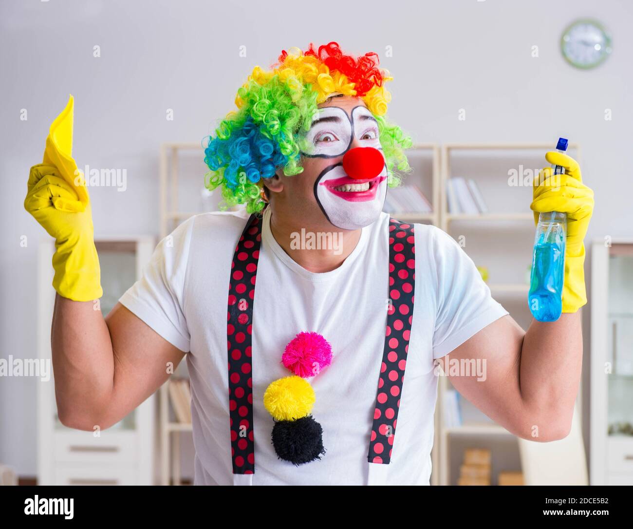 The funny clown doing cleaning at home Stock Photo - Alamy
