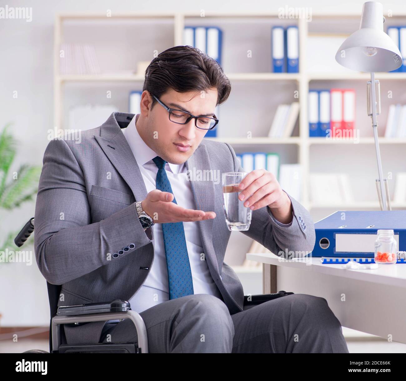 The disabled businessman working in the office Stock Photo - Alamy