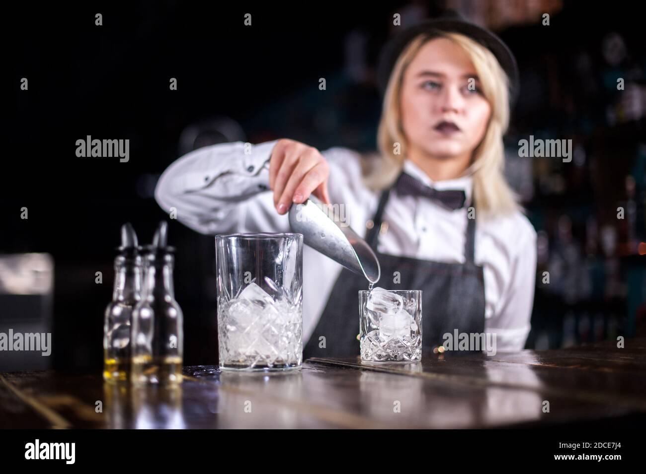 Young woman bartending demonstrates his professional skills in the ...