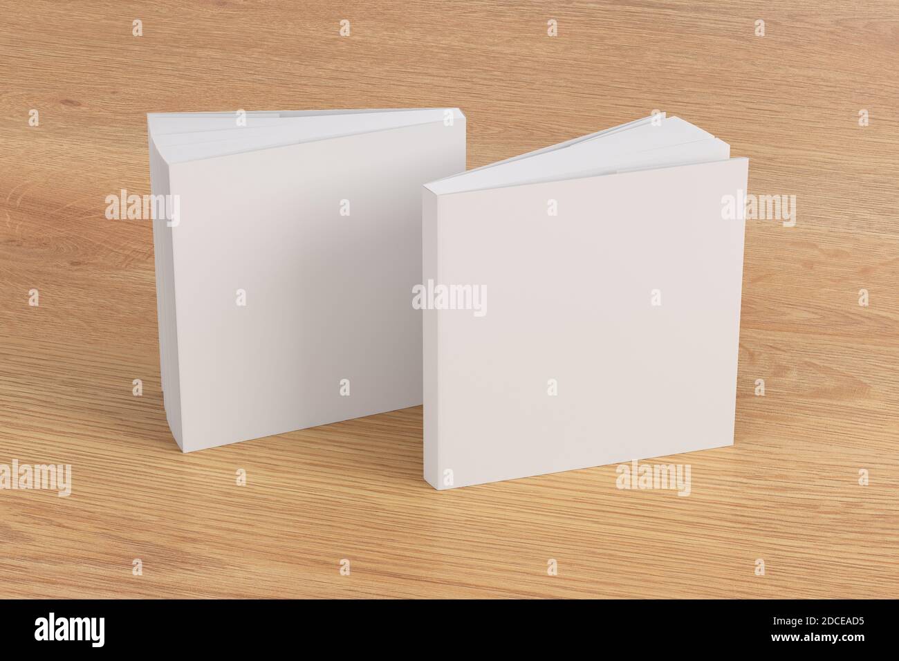 Two softcover or paperback square white mockup books standing on the ...