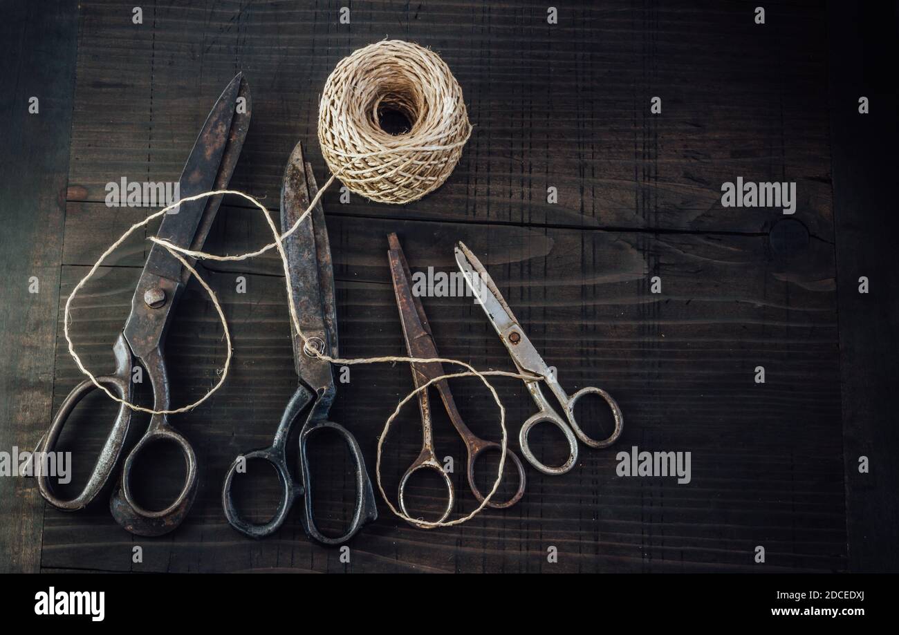 Old vintage rusty scissors with thread yarn twine ball. Top view ...
