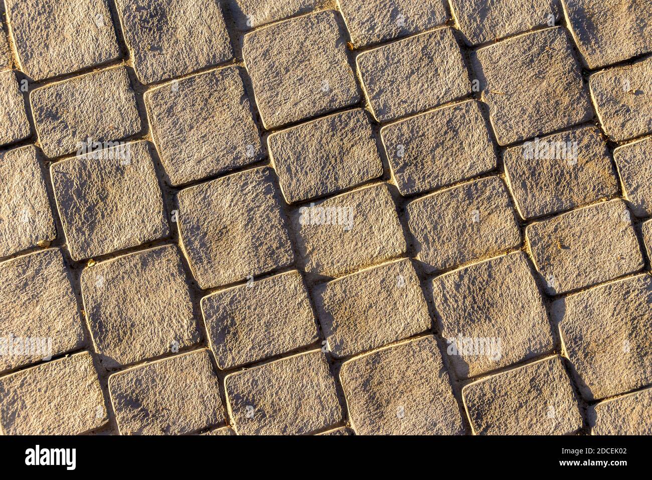 stone paved path, diagonal direction with side light Stock Photo - Alamy