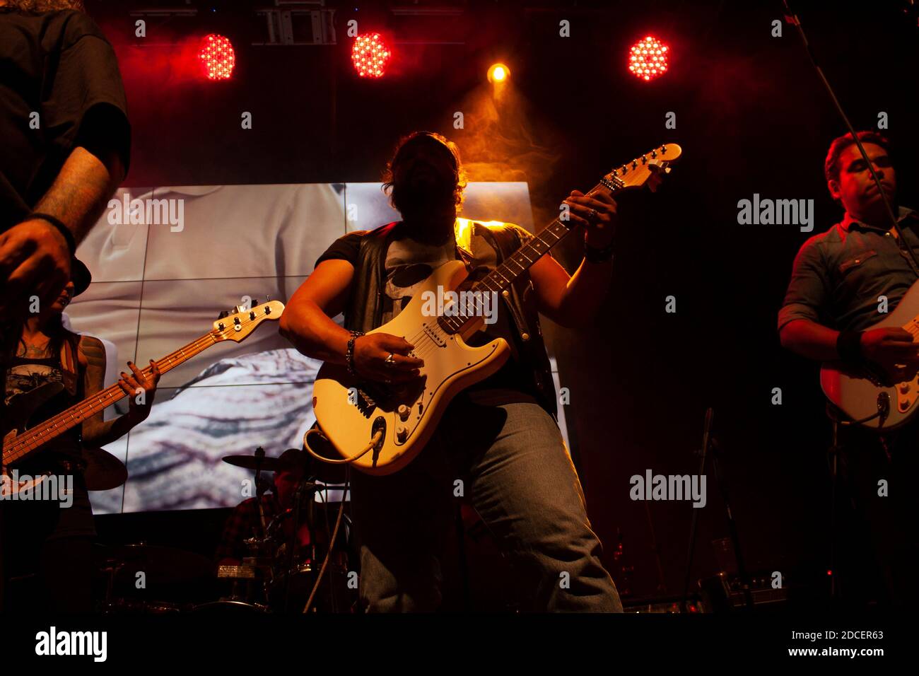 Rock band setting nightlife in Mexico city latin america string trio with two electric guitars ...