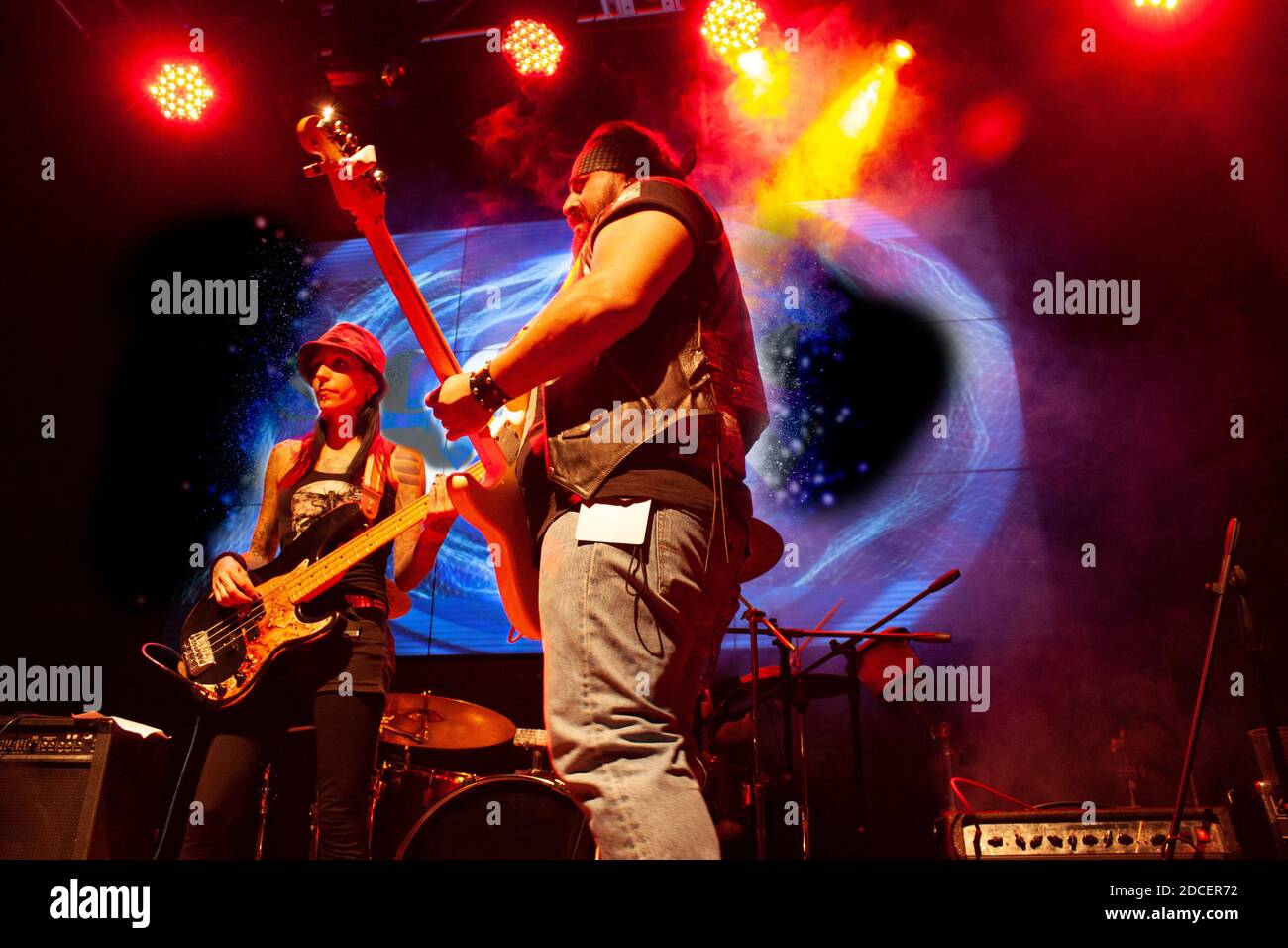 Pair of people woman bassist playing bass strings and man guitarist ...