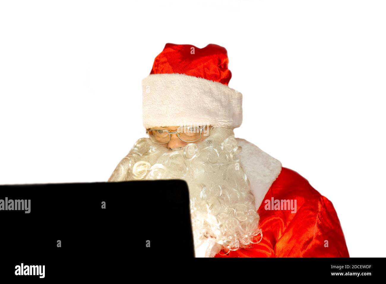 Santa Claus with a laptop in his hands. Santa uses new technologies ...