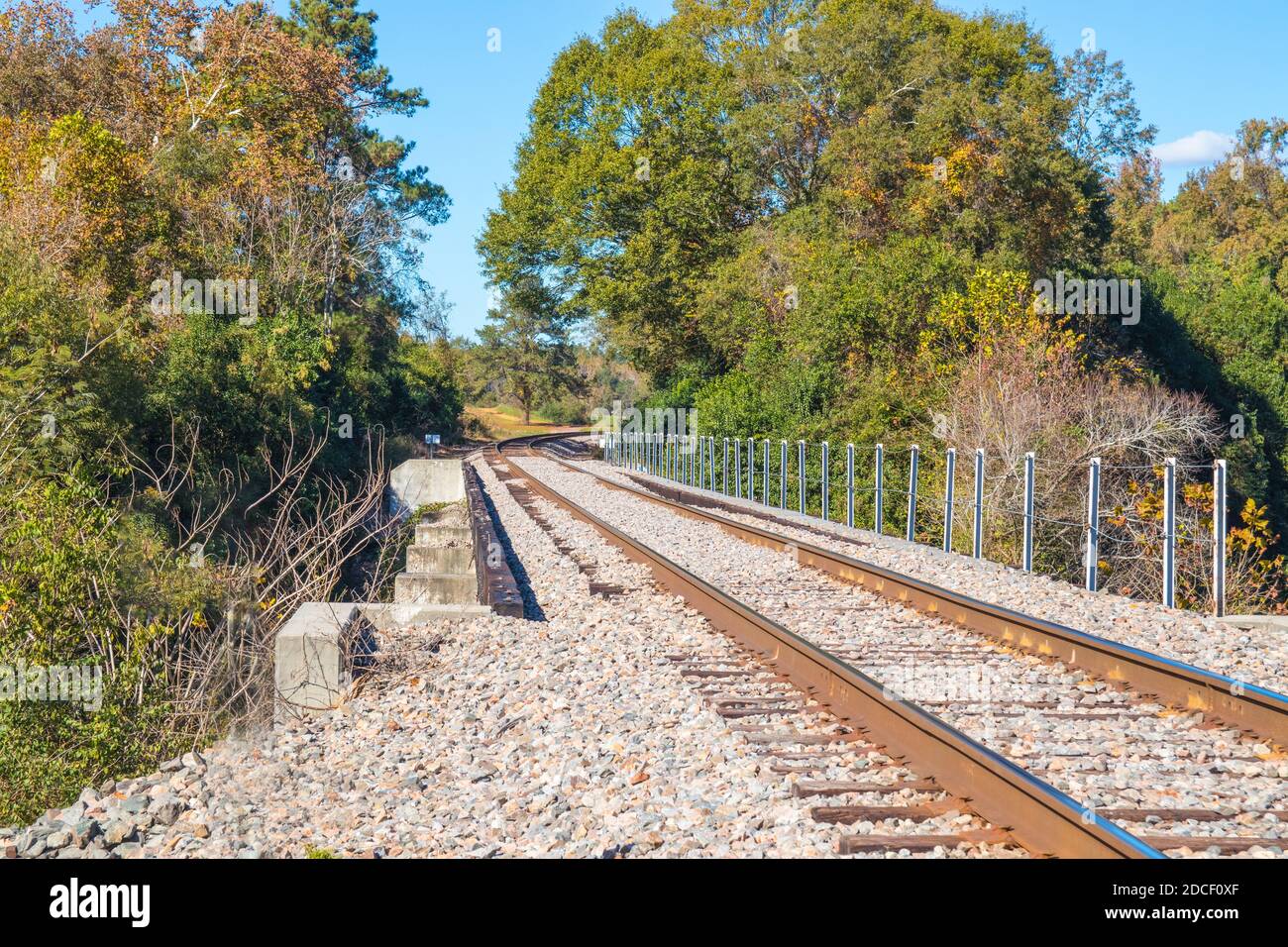 View of a long train track curving in to the countryside Stock Photo ...