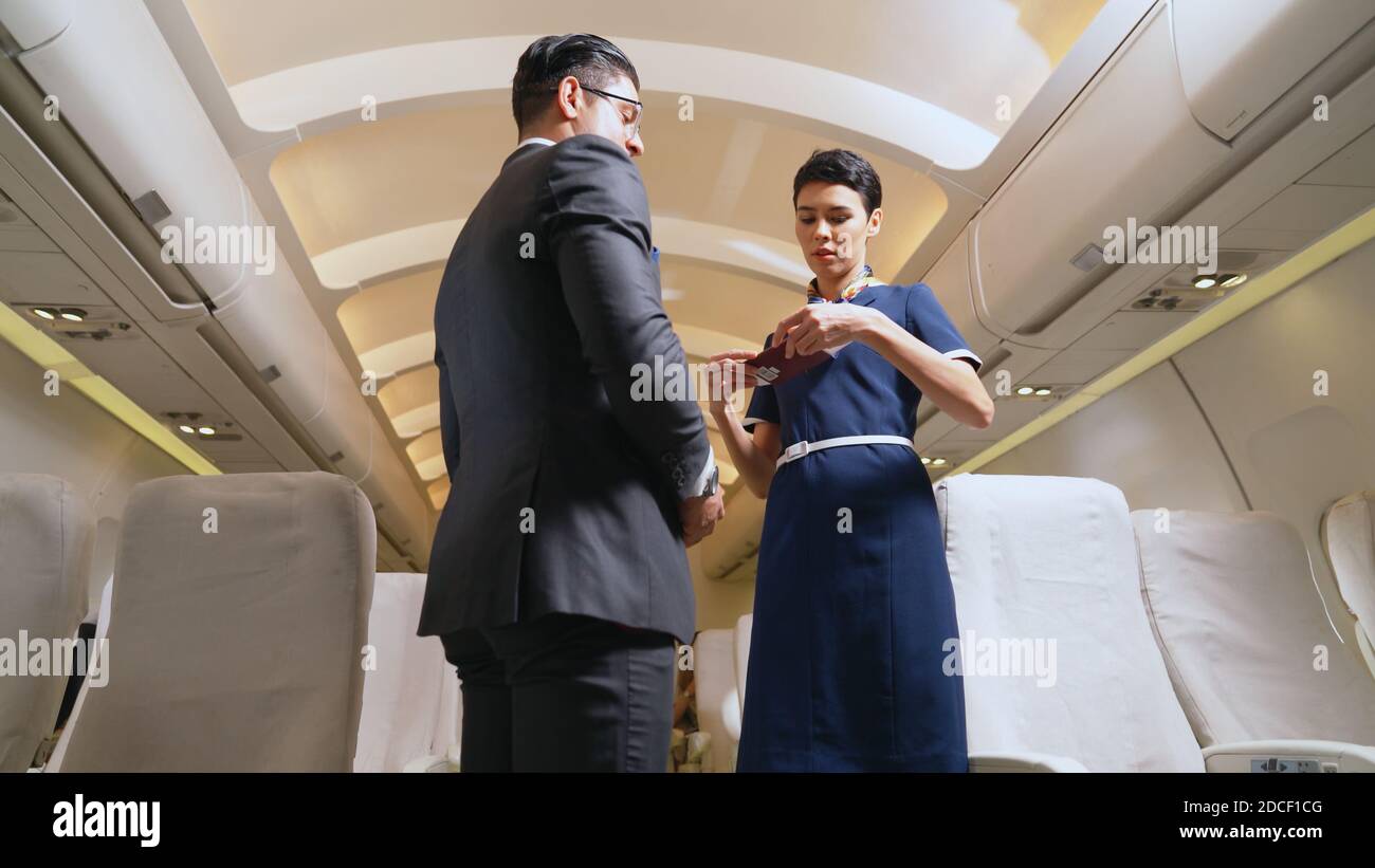 Flight attendant greeting passenger hi-res stock photography and images ...