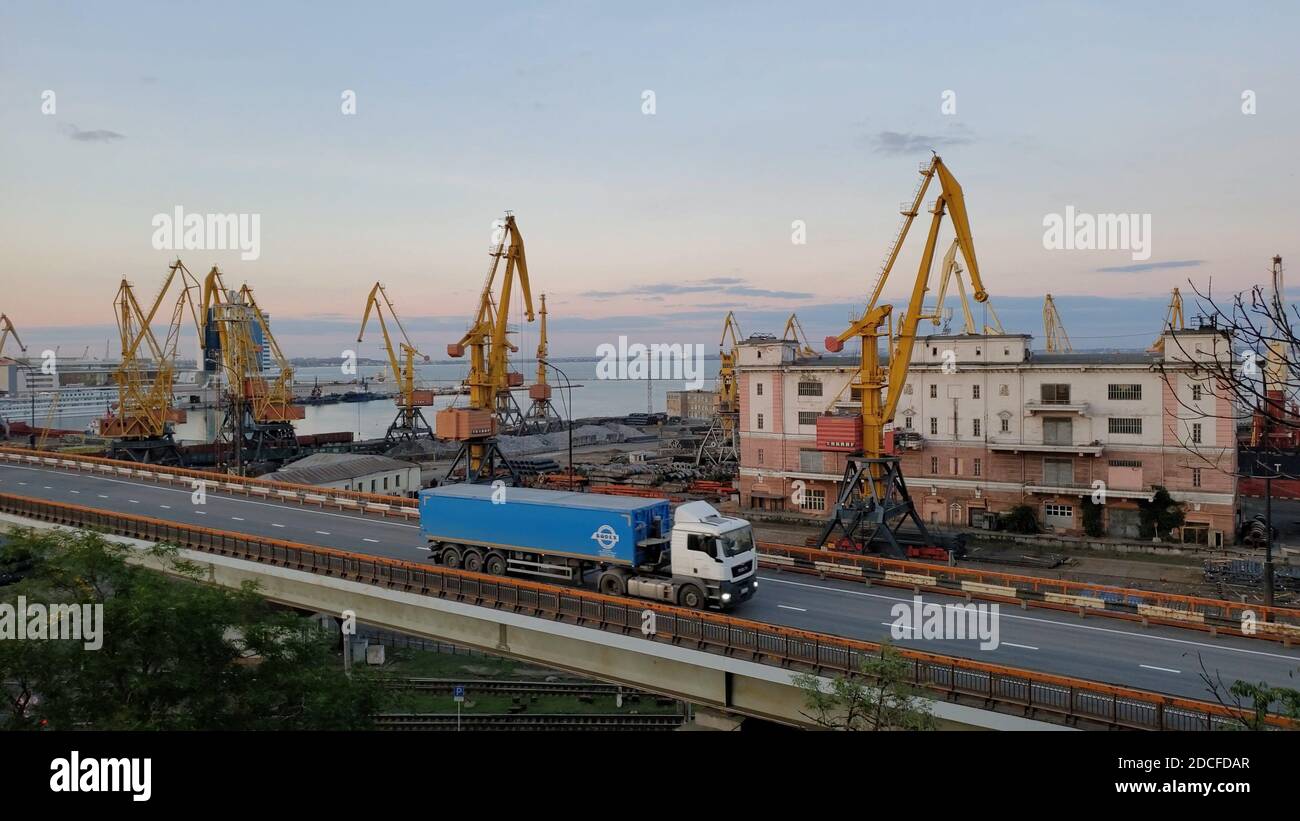 Container truck driving by elevated road of port cargo terminal ...