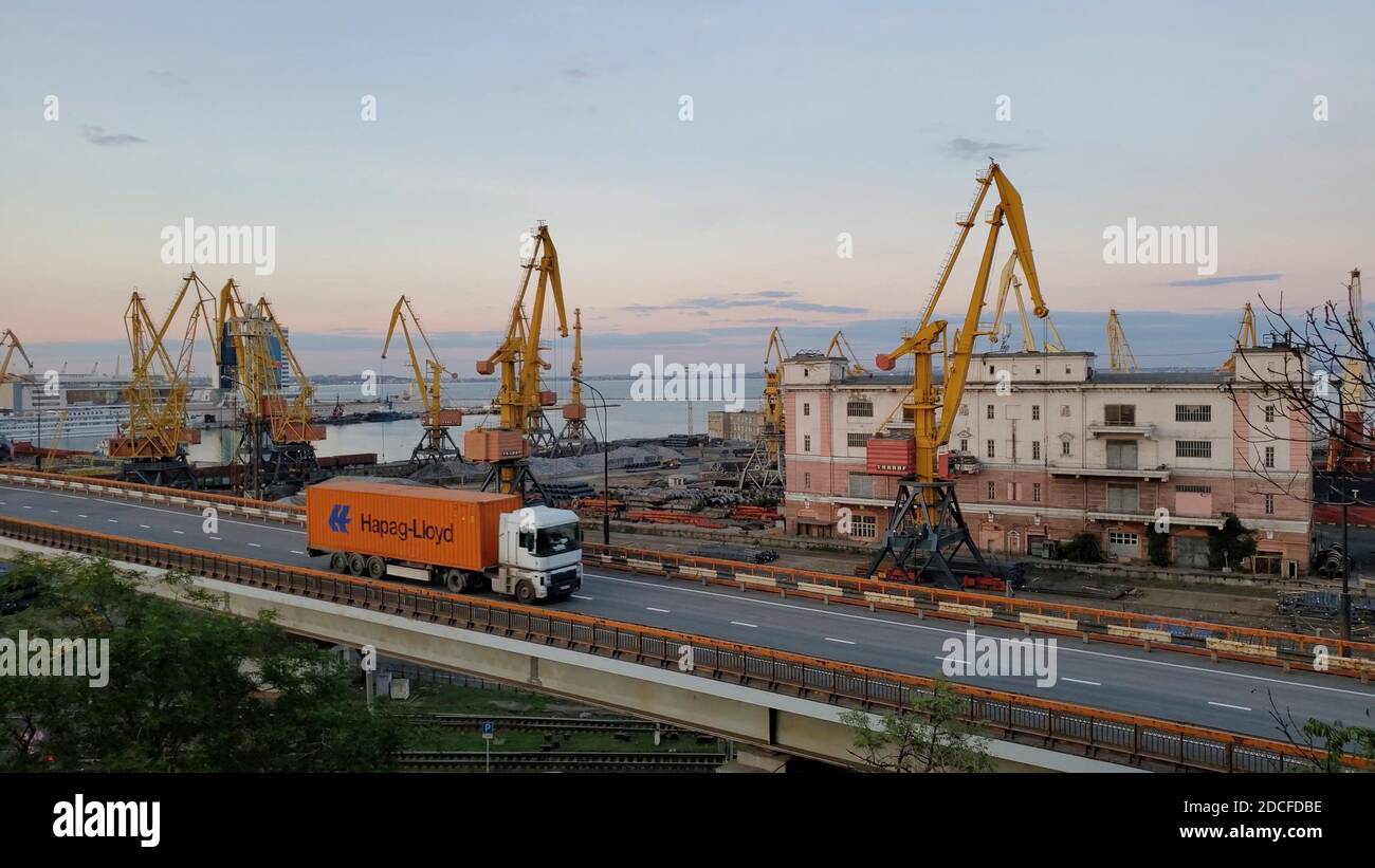 Cargo vehicle trailer carrying orange container Hapag Lloyd driving by ...