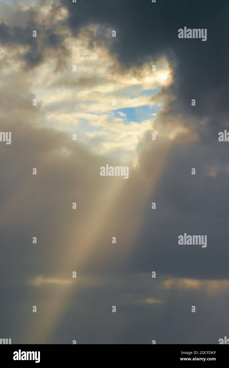 Sunbeams shine through the storm clouds after tropical storm. Gulf of ...