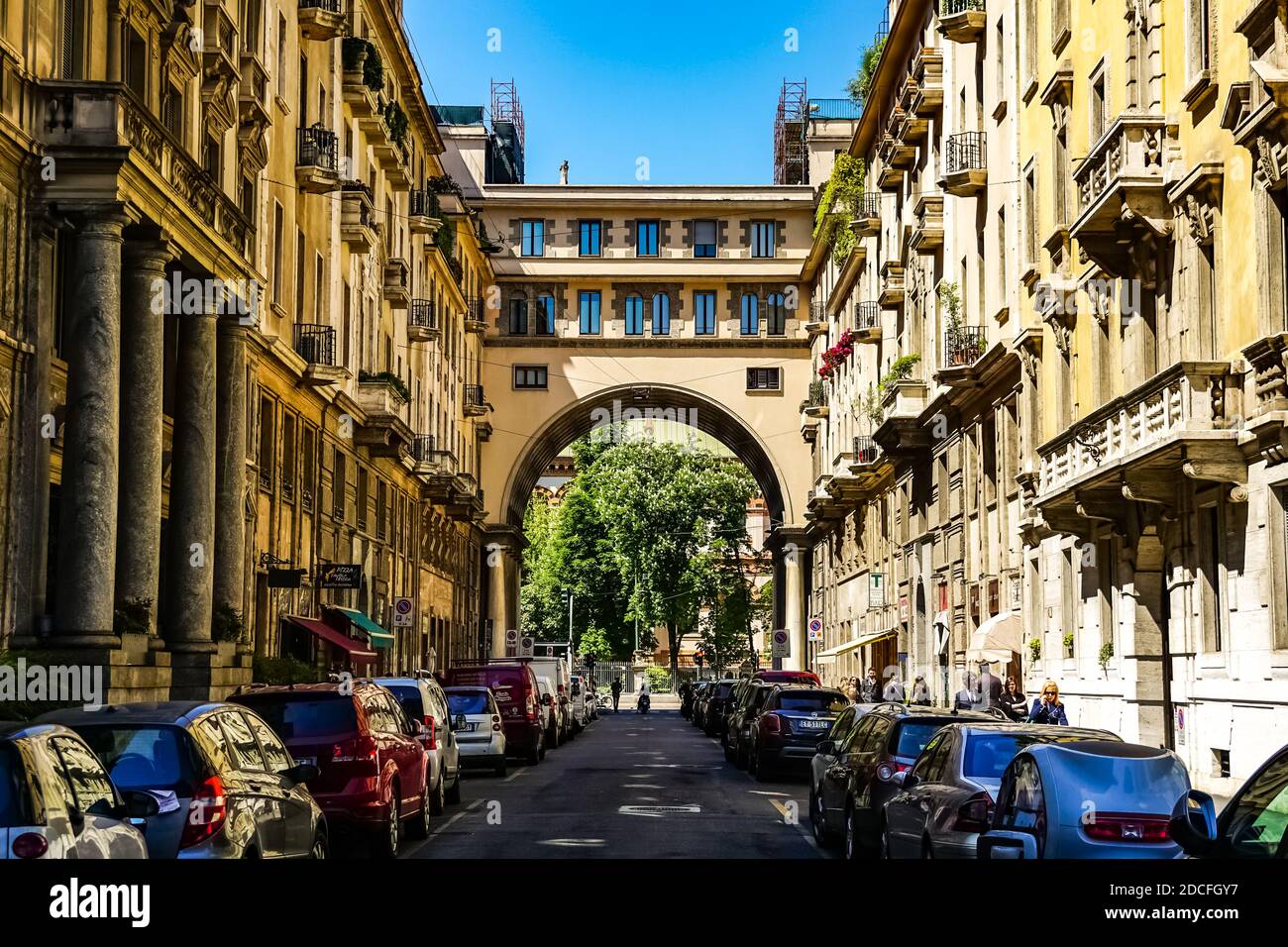 Milan street panorama with Milan trams, pedestrians and cars on a sunny ...