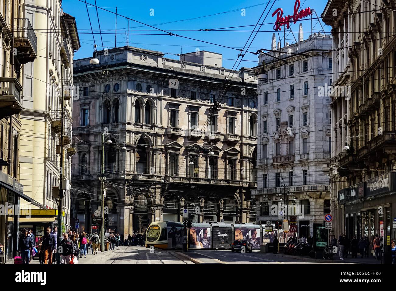Milan street panorama with Milan trams, pedestrians and cars on a sunny ...