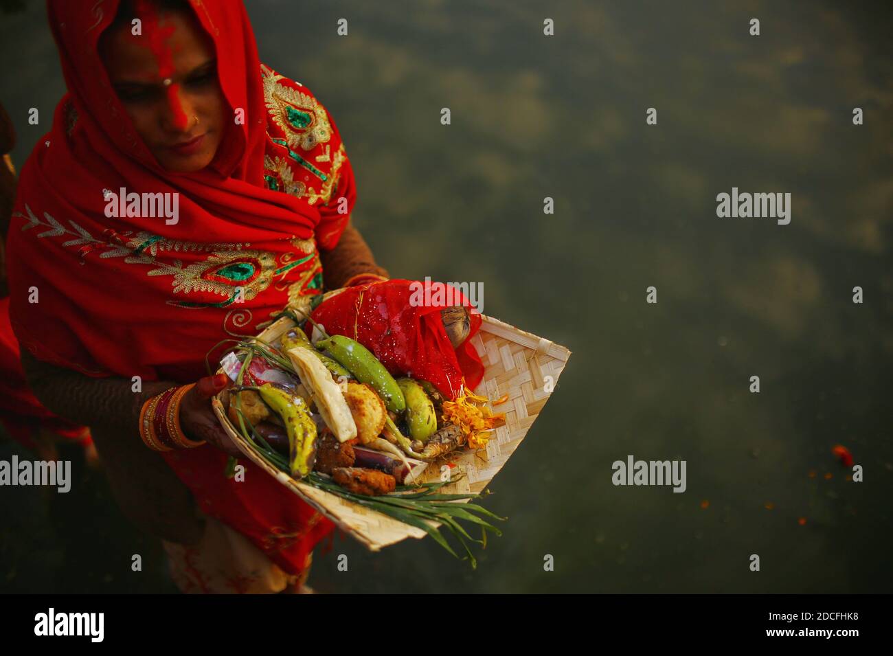 Kathmandu, Nepal. 21st Nov, 2020. A devotee offers prayer to the rising ...