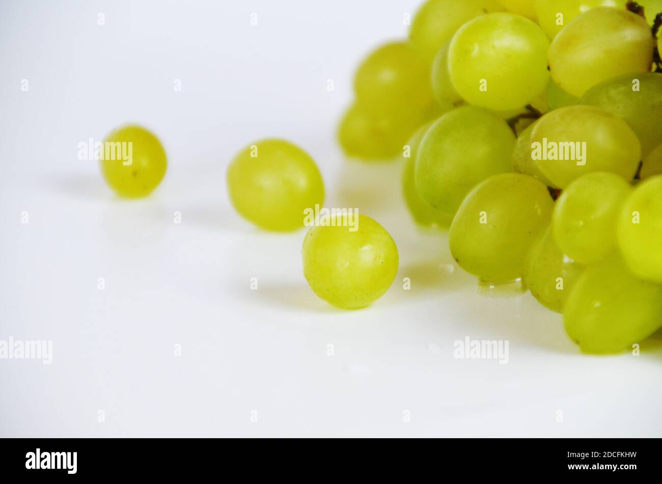 Fresh green grapes with leaves. Isolated on white close up Stock Photo ...