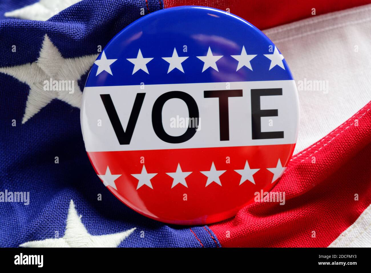 A red, white and blue VOTE button on a blue background Stock Photo - Alamy
