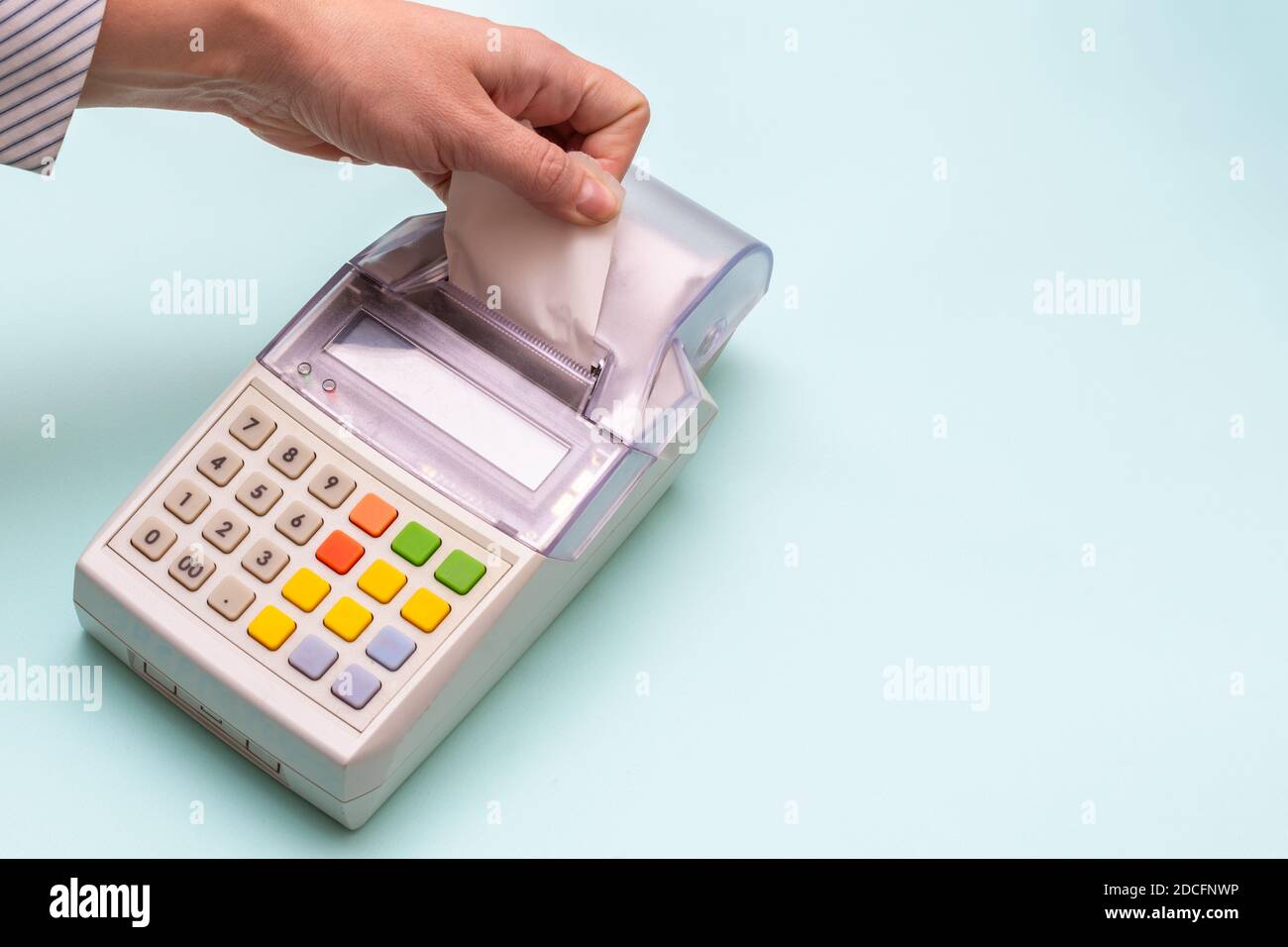 Close-up of a woman's hand tearing a check from a cash register on a ...
