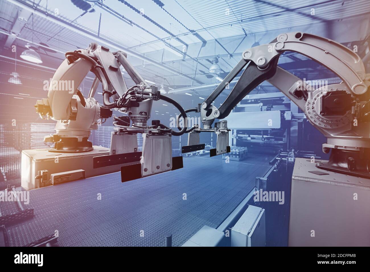 Robot arm manipulator. Modern packaging line for water and beer and ...