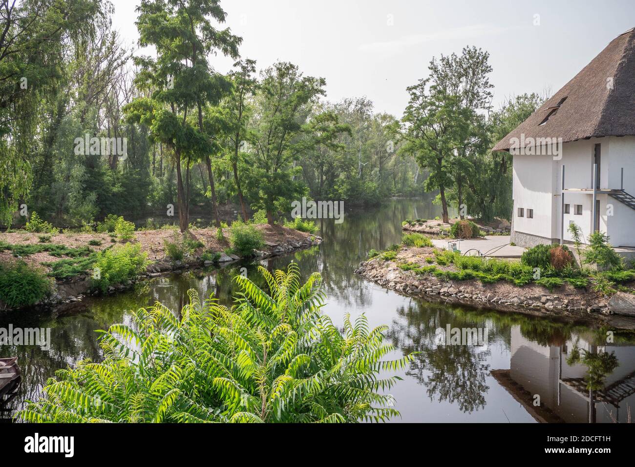Water around the house with white walls and an authentic roof ...